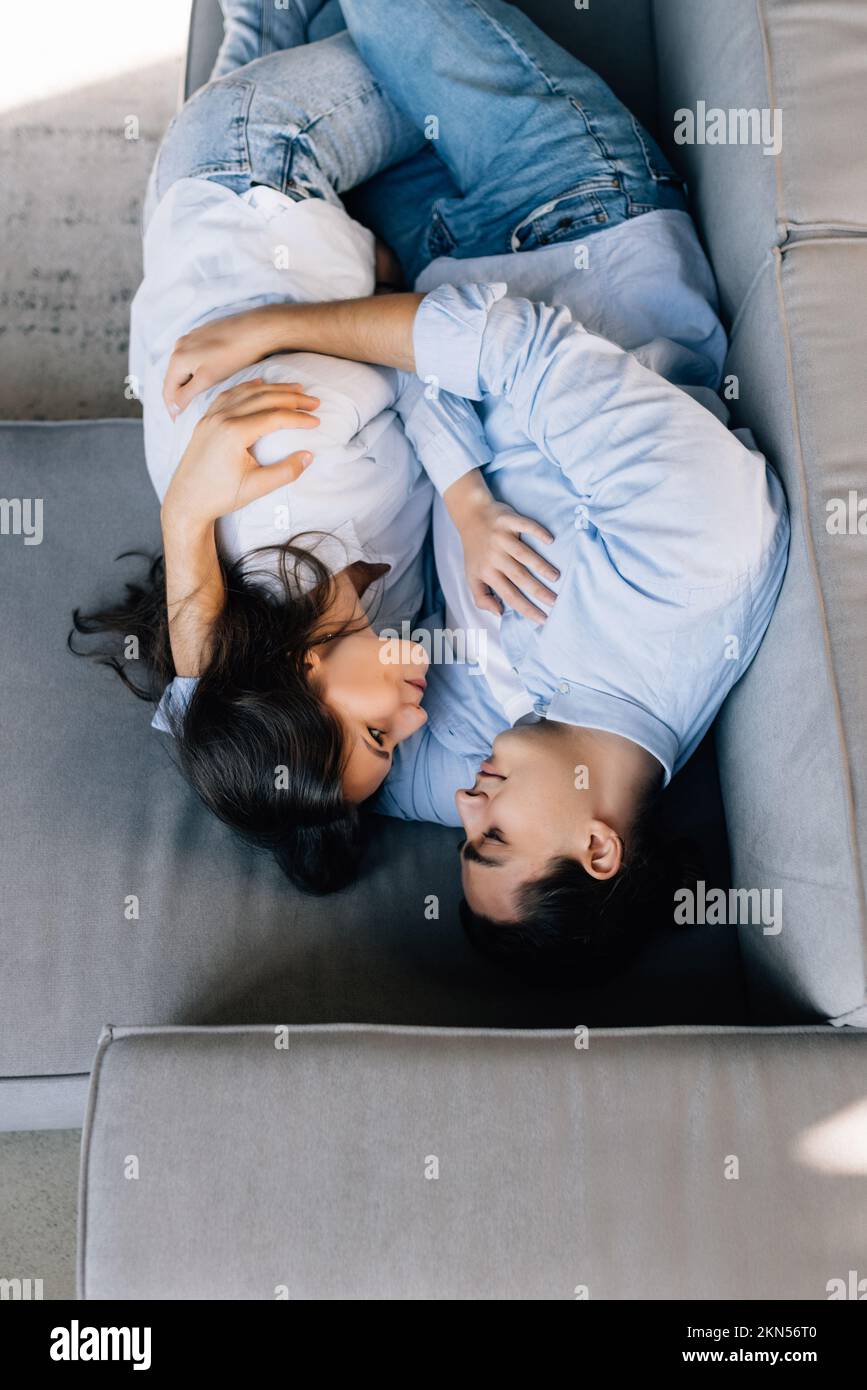 Loving relaxed couple kissing in the living room at home Stock Photo ...