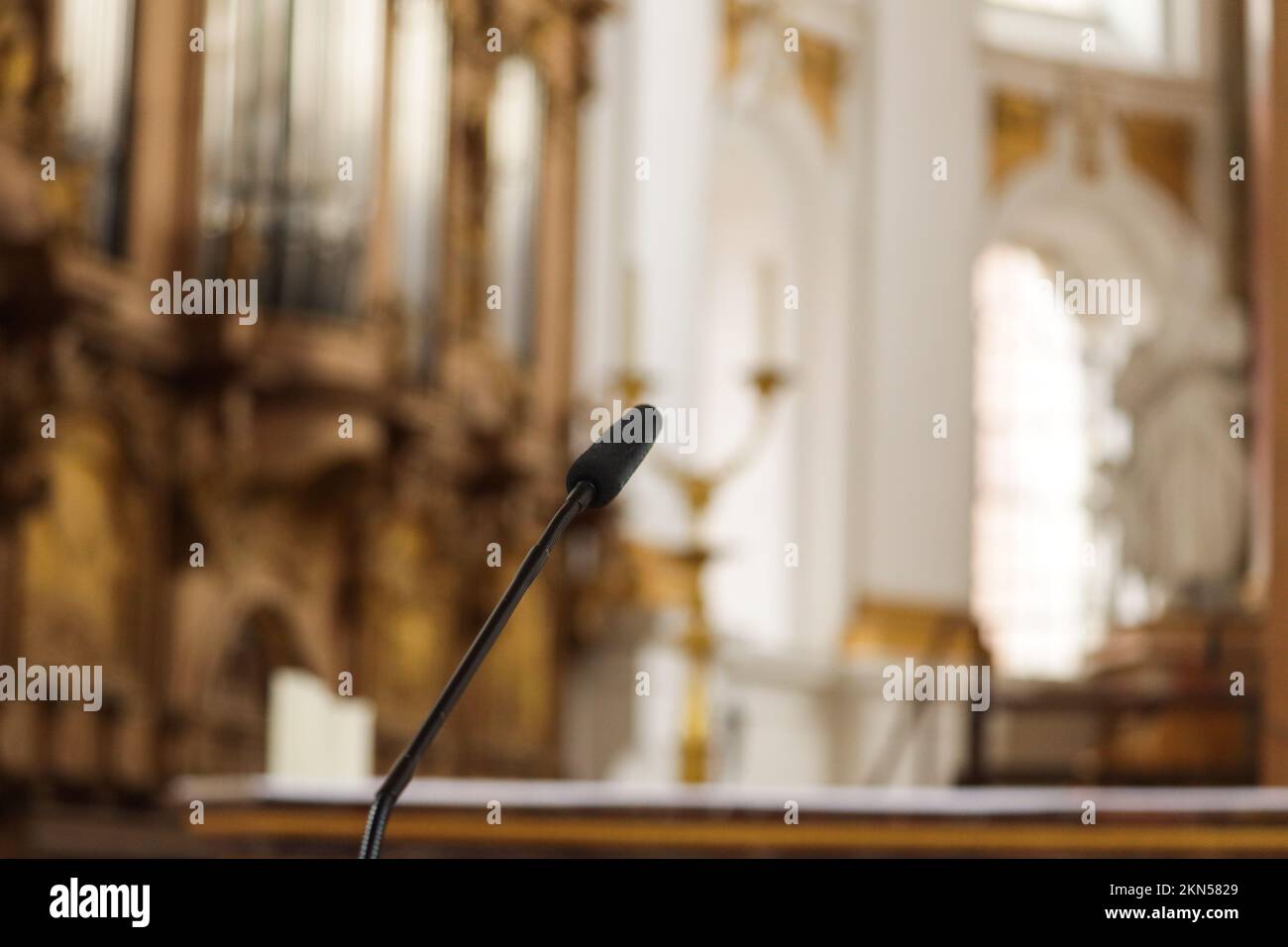 A long microphone on podium with blur arch walls Stock Photo - Alamy