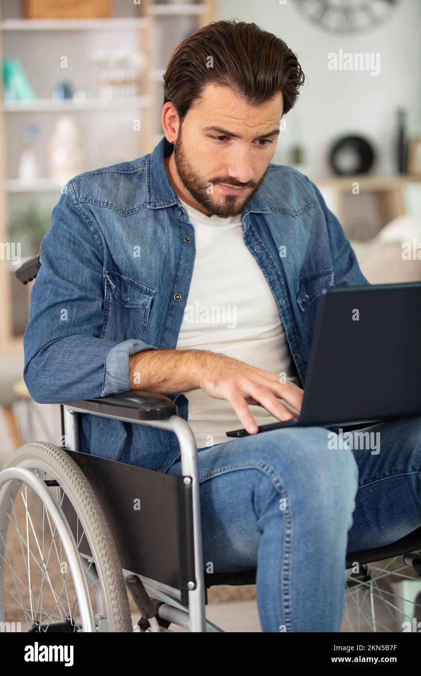disabled person in the wheelchair works in the office Stock Photo - Alamy