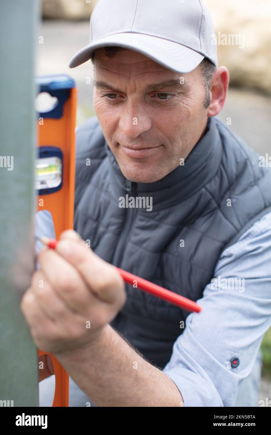 carpenter marking straight line on metal bar Stock Photo - Alamy