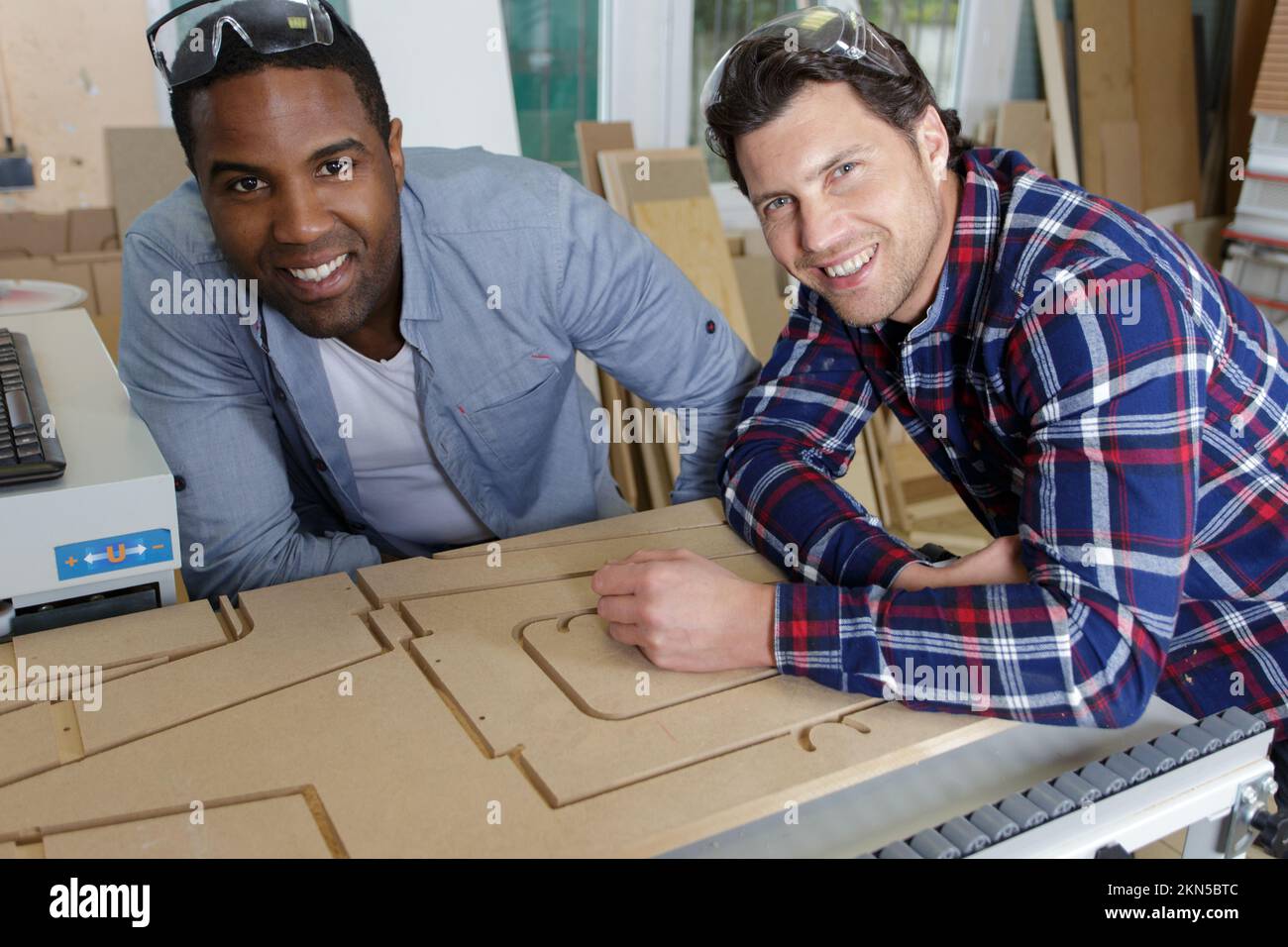 worker standing posing by wood cutting machine Stock Photo - Alamy
