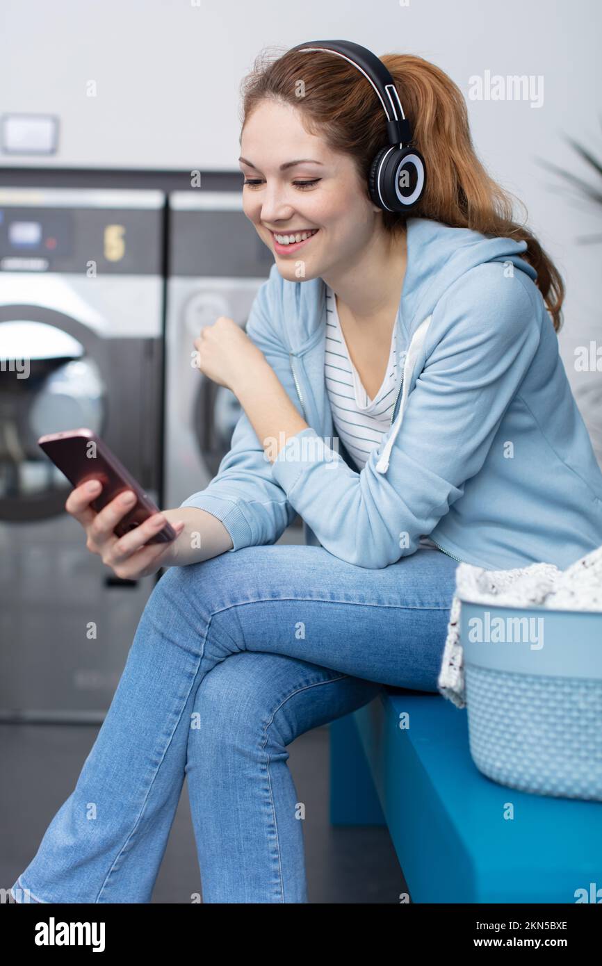happy woman listening to music in the laundry Stock Photo - Alamy