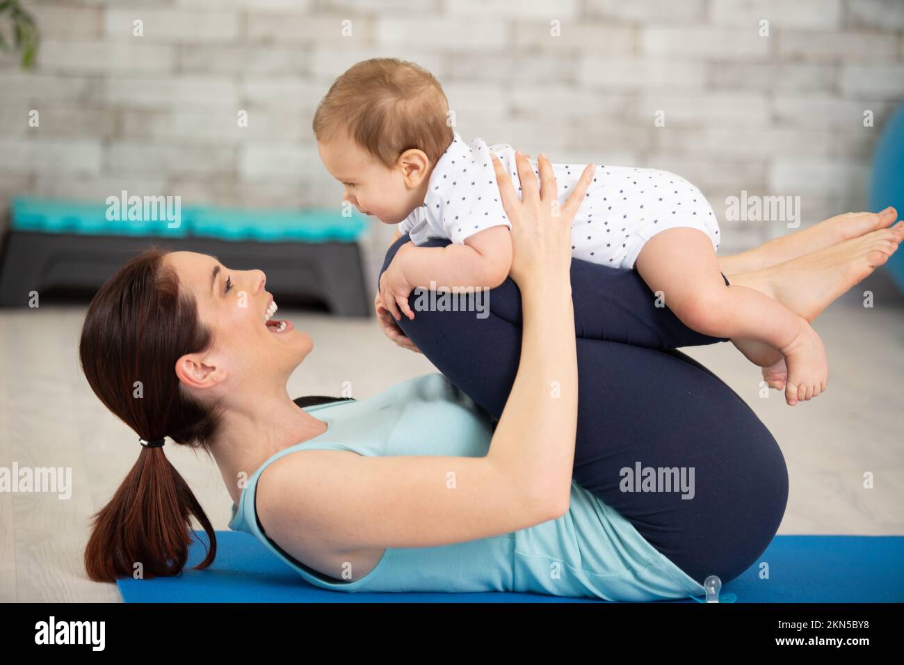 beautiful pregnant woman doing fitness exercise with baby Stock Photo ...