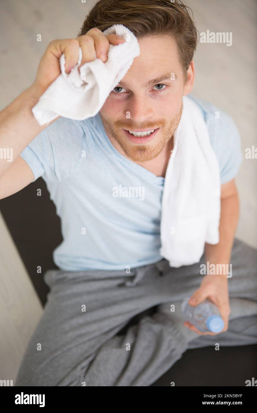 handsome man wiping his head after his indoor exercise Stock Photo - Alamy