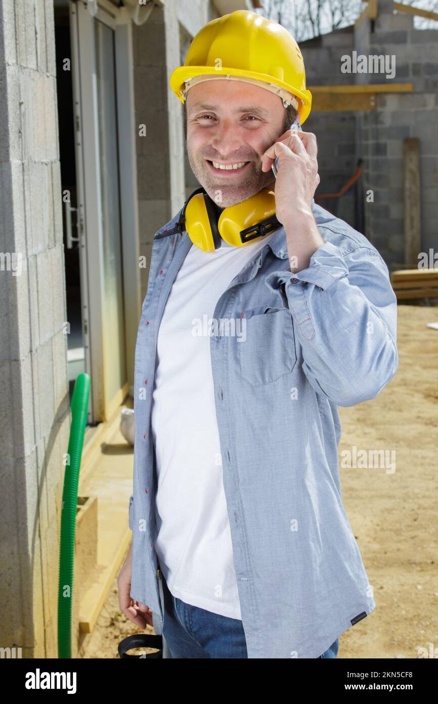 construction worker talking on the phone at a building site Stock Photo ...
