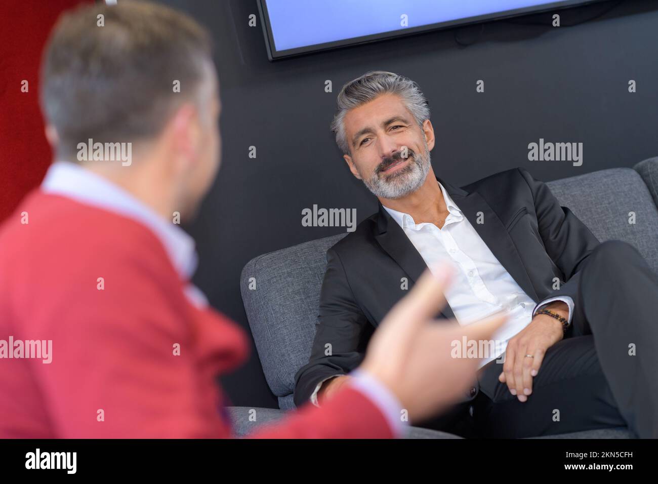 two businessmen discussing something at workplace Stock Photo - Alamy