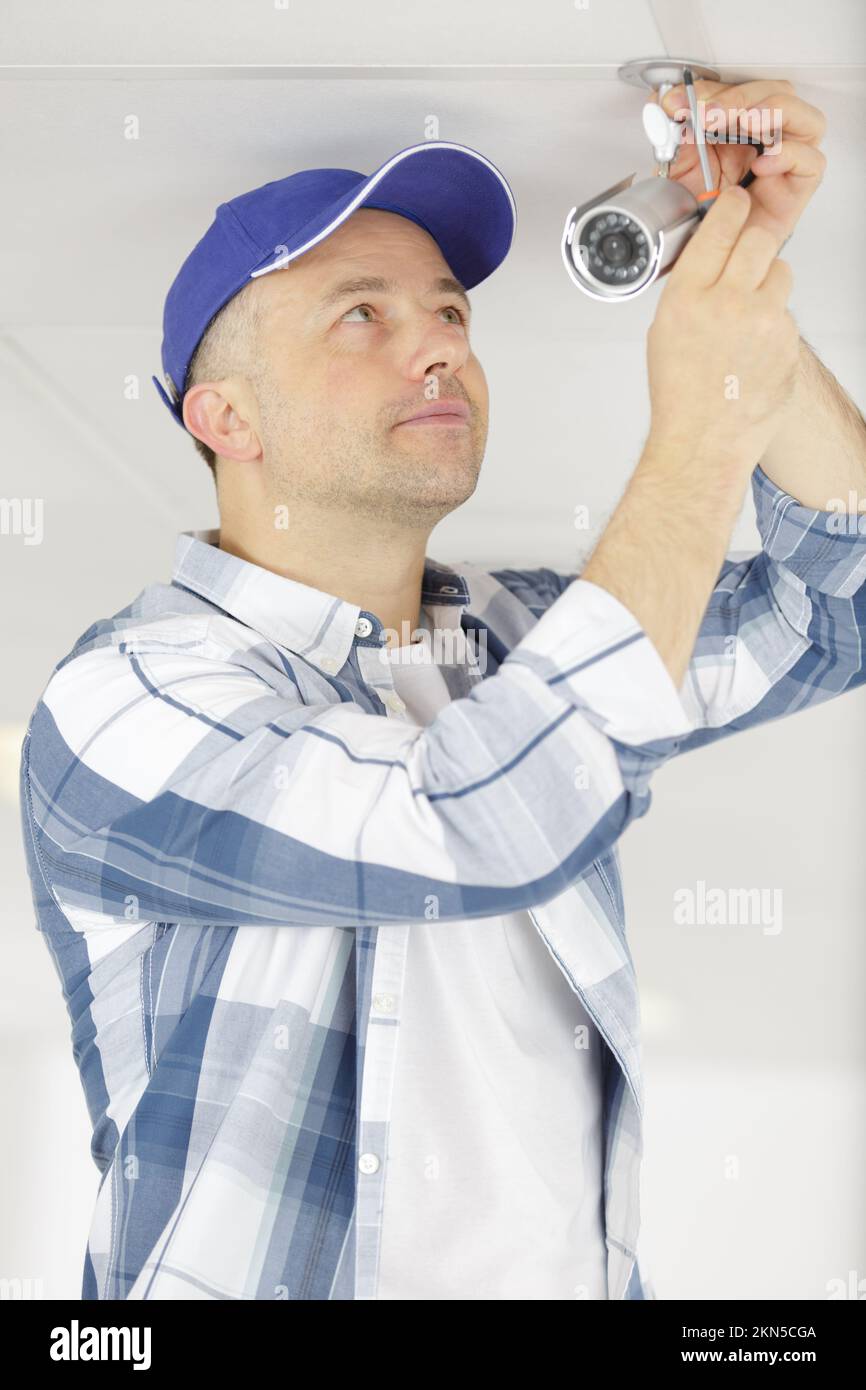 contractor installing surveillance cctv cameras in office Stock Photo ...