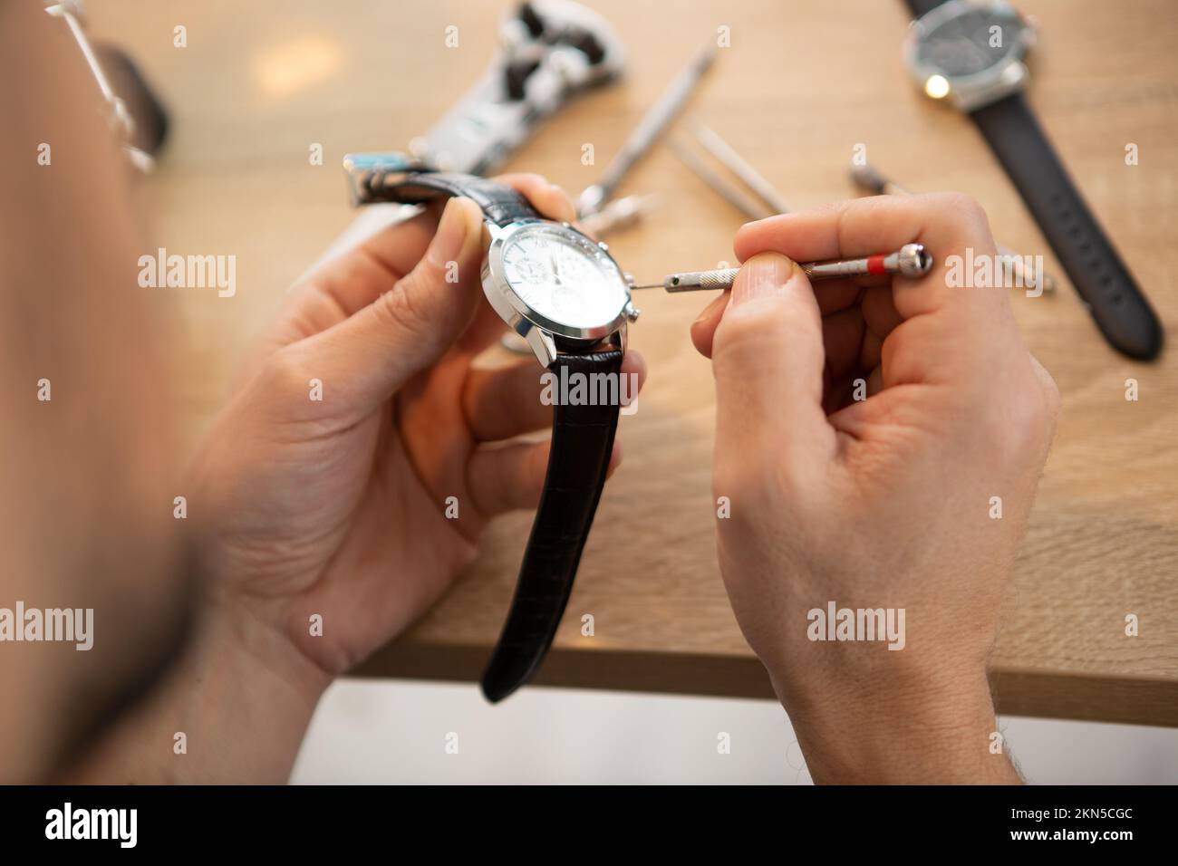 the watchmaker is repairing the mechanical watches in his workshop ...