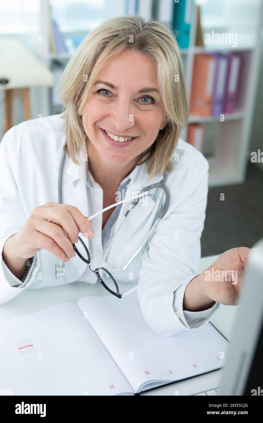 female doctor working at office desk Stock Photo - Alamy