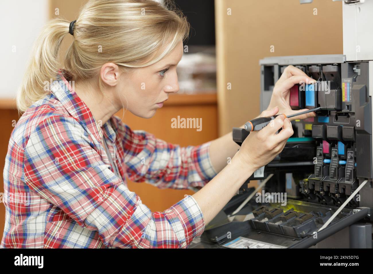 female technician fixing a printer Stock Photo - Alamy