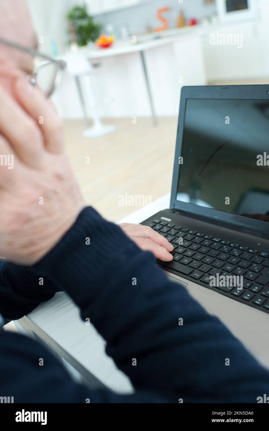 Curious senior laptop computer hi-res stock photography and images - Alamy