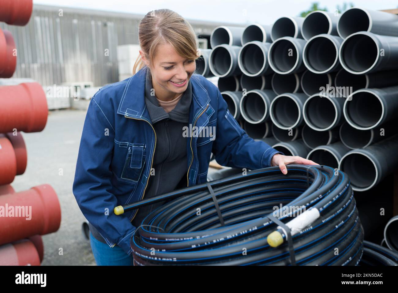 female worker dealing with pipes Stock Photo - Alamy
