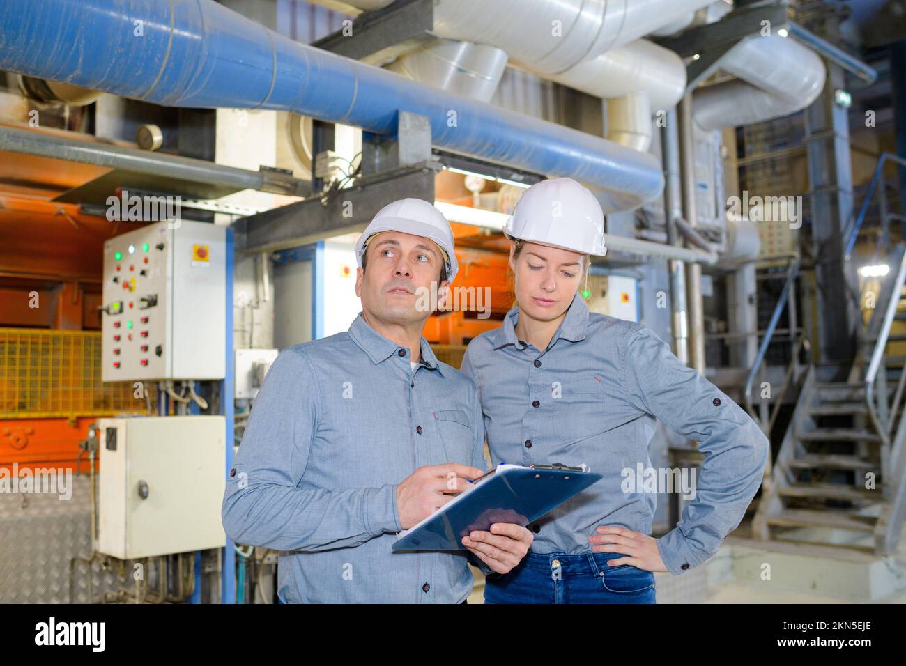 factory engineers operating hydraulic tube bender Stock Photo - Alamy