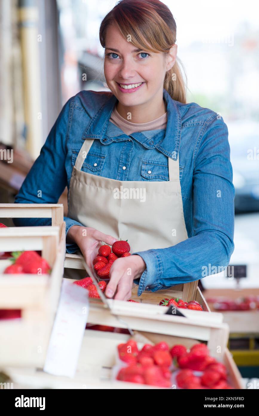 female grocer unpacking crates of strawberries Stock Photo - Alamy