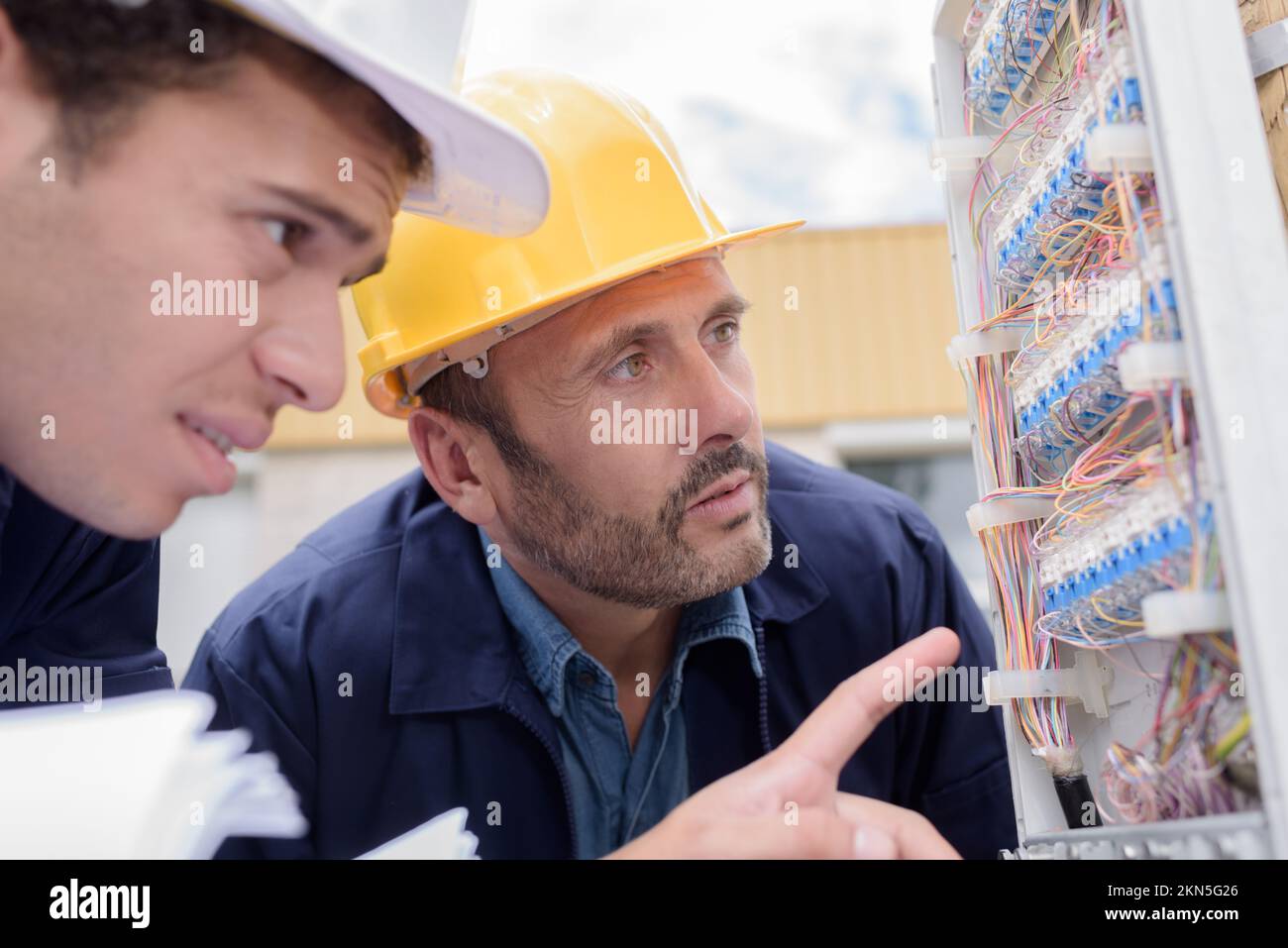 two technicians working with cables Stock Photo - Alamy