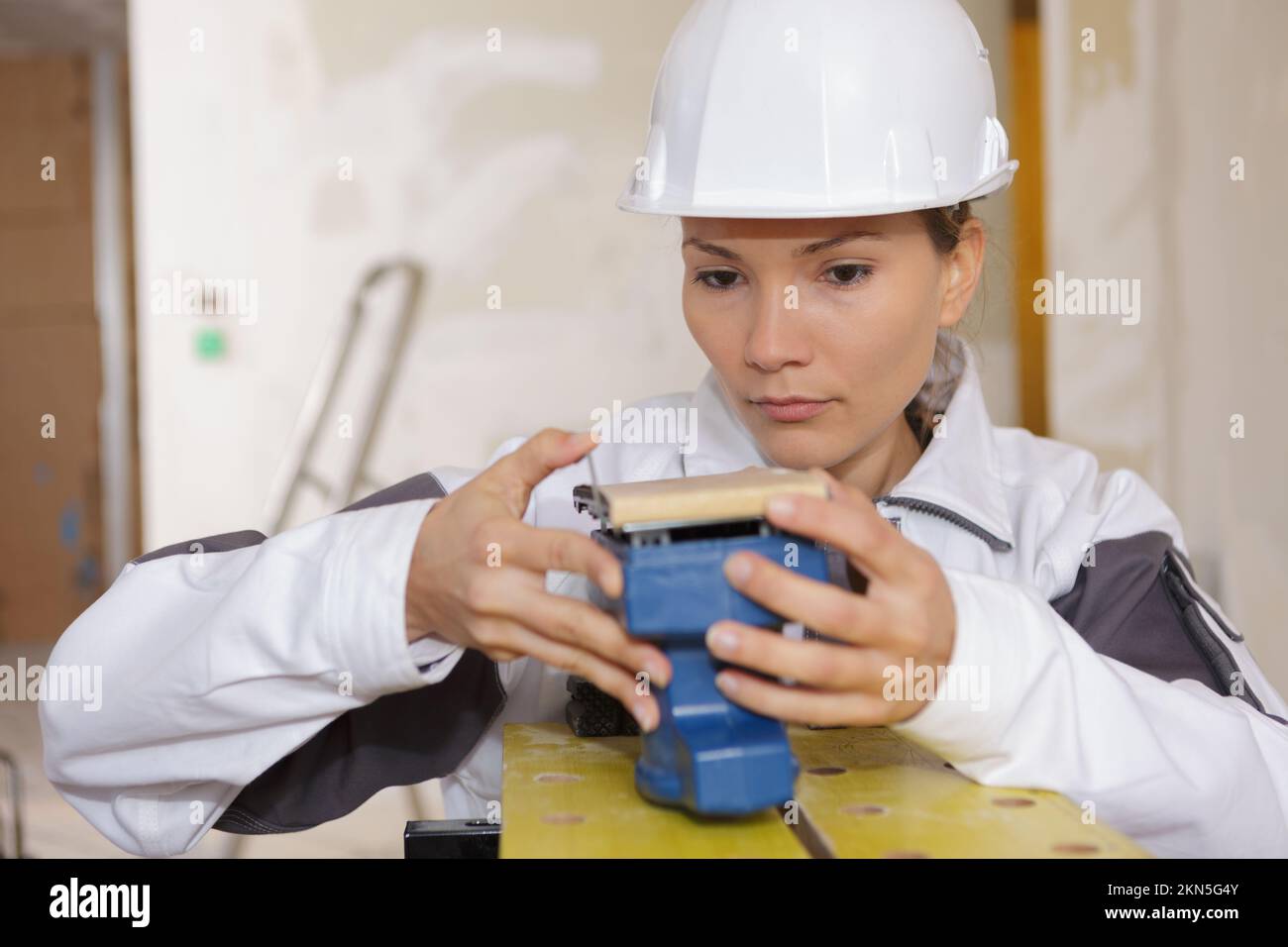 female construction fixing sanding machine Stock Photo - Alamy