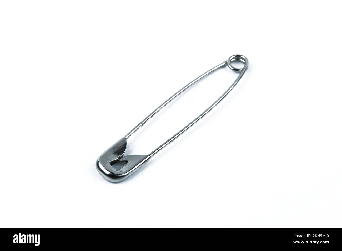 Safety pin isolated on white background Stock Photo - Alamy