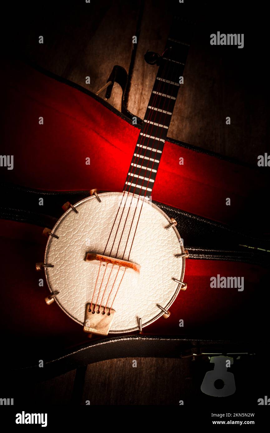 Shadowed scene of bluegrass classics with open instrument case ...