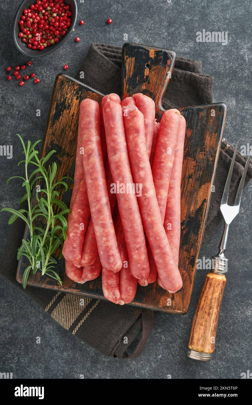 Meat beef sausages. Raw barbecue sausages with spices, vegetables and ...