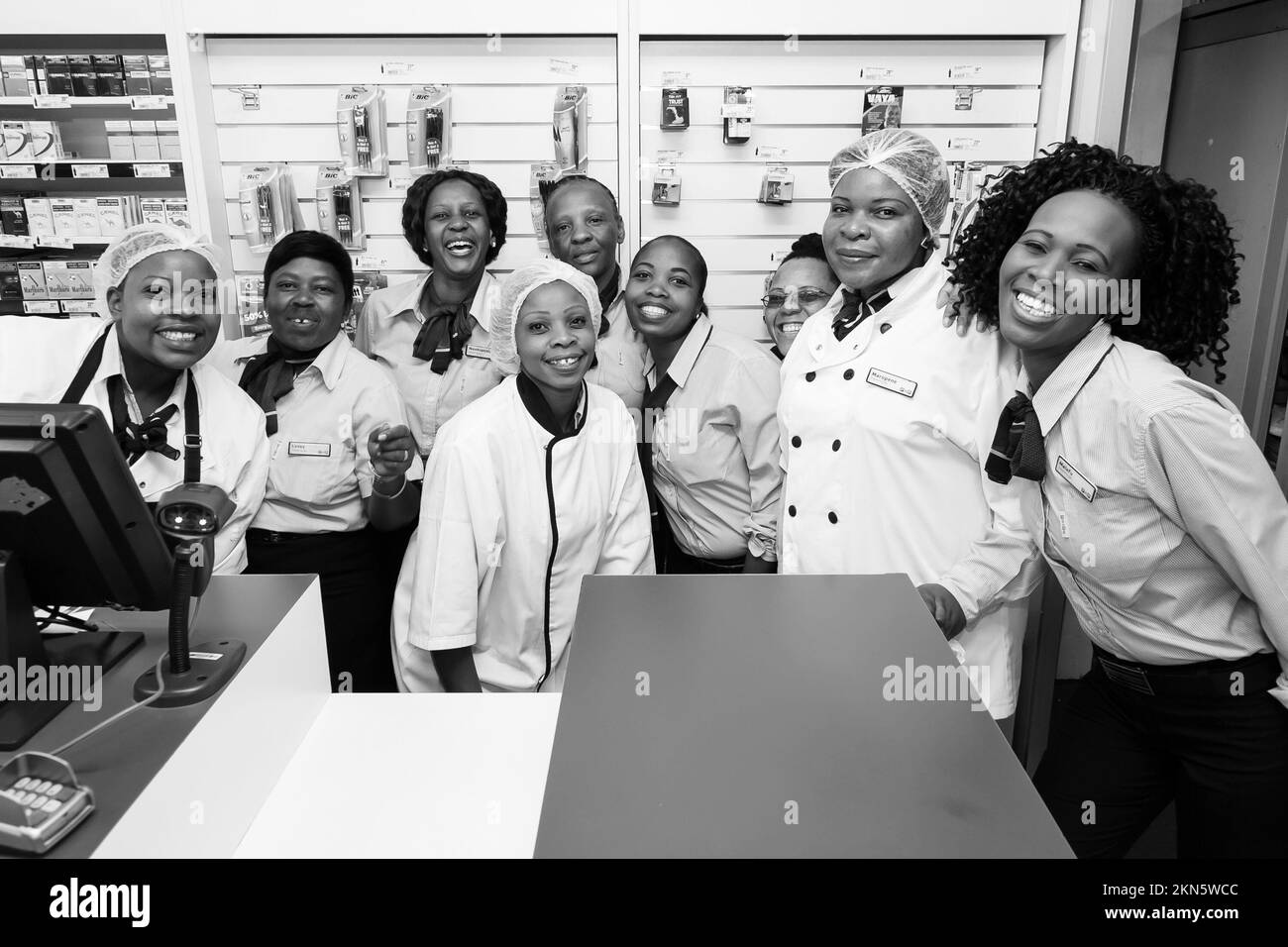 A grayscale shot of happy staff members of Pick 'n Pay grocery shop ...