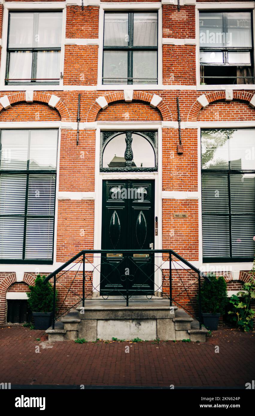A modern house made of bricks with many windows Stock Photo - Alamy