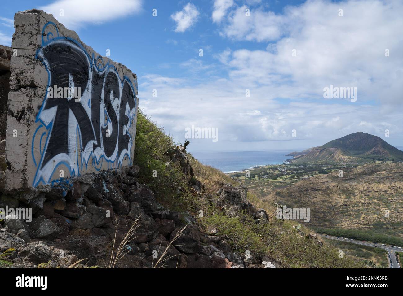 Rise up graffiti on a wall on top of a mountain with a nice view on ...