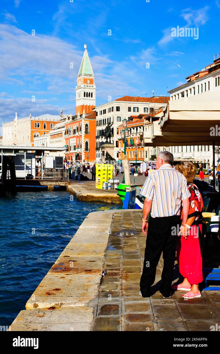 St. Mark's vaporetto station in Venice, Italy. People on the waterfront ...