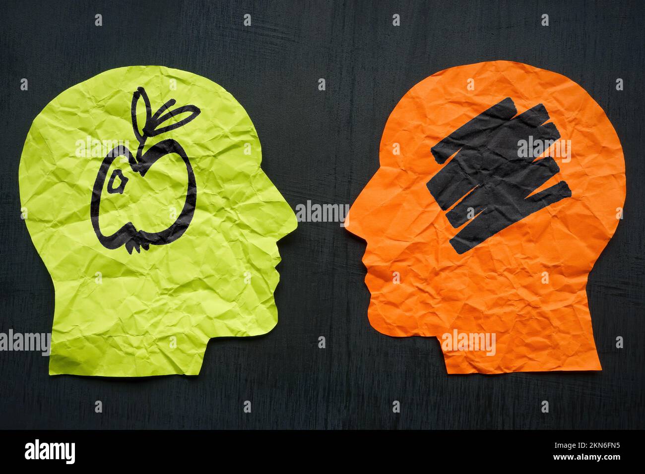 Two heads from paper and one with apple. Aphantasia concept Stock Photo ...