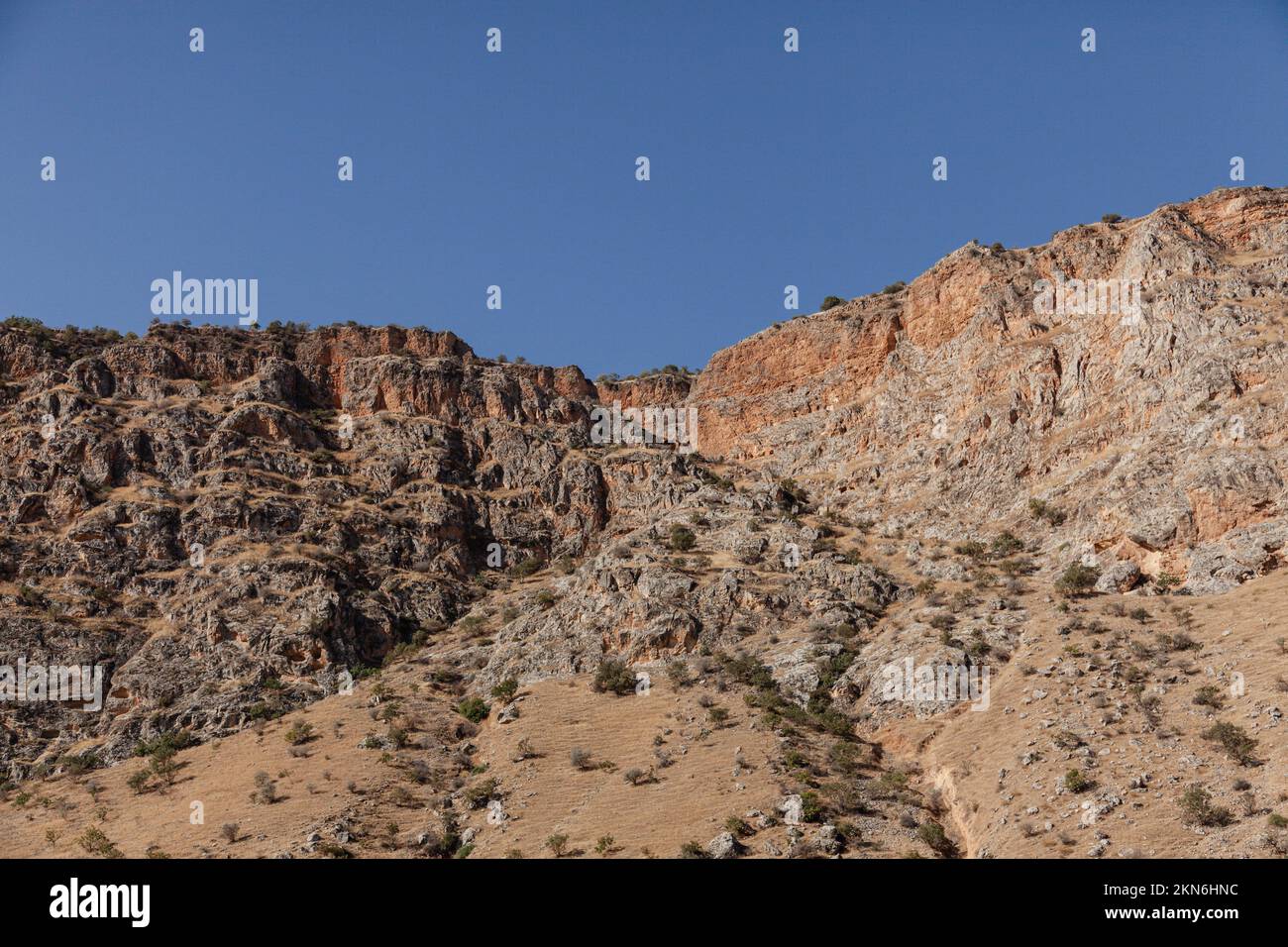 View of a steep rocky valley with blue sky Stock Photo - Alamy