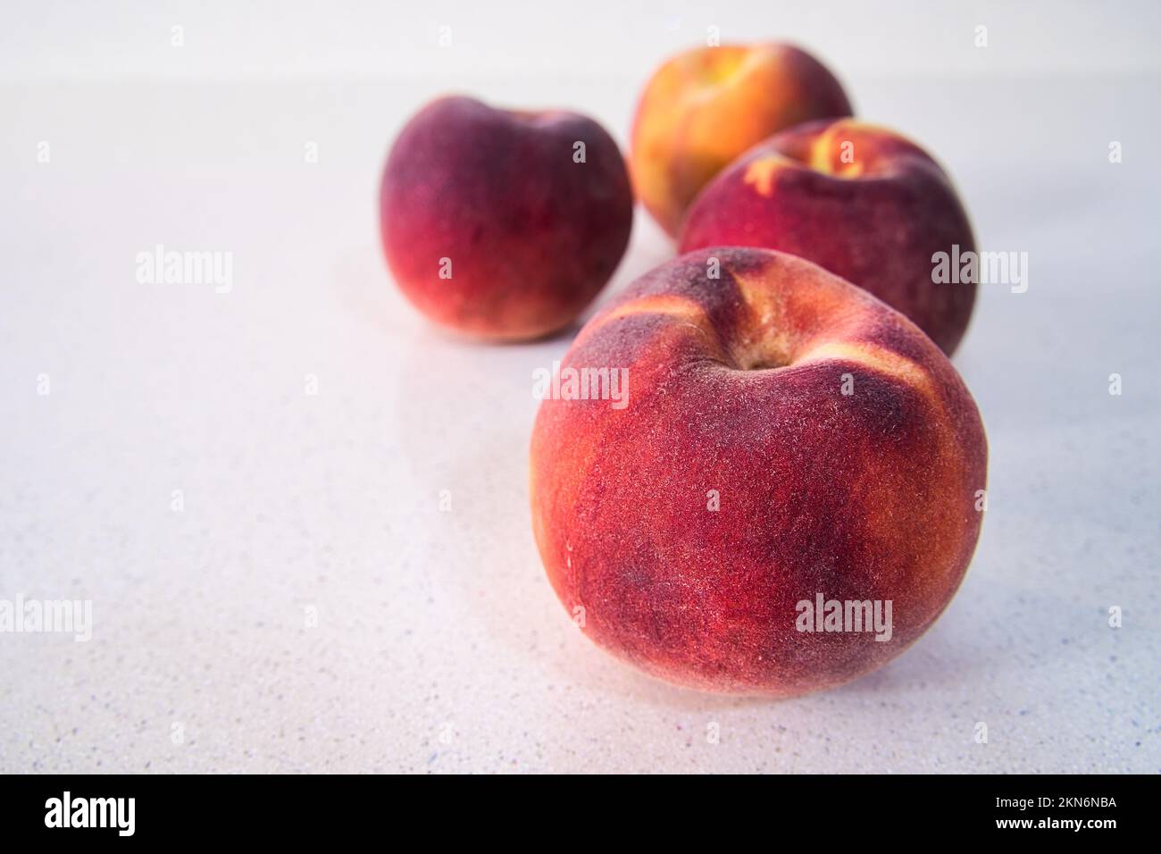 Four peaches isolated on a white background Stock Photo - Alamy