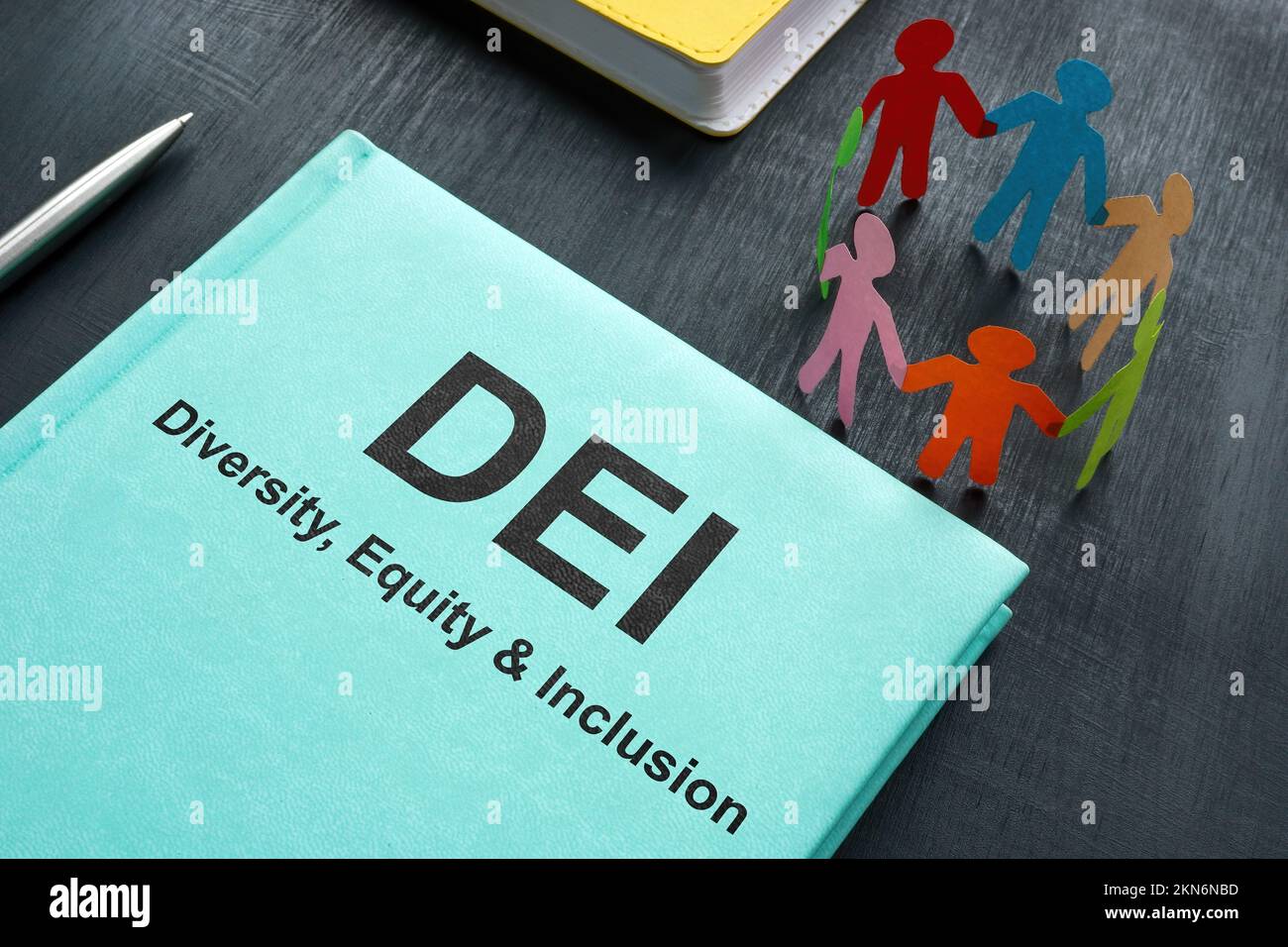 Book about DEI diversity, equity and inclusion and paper figurines ...