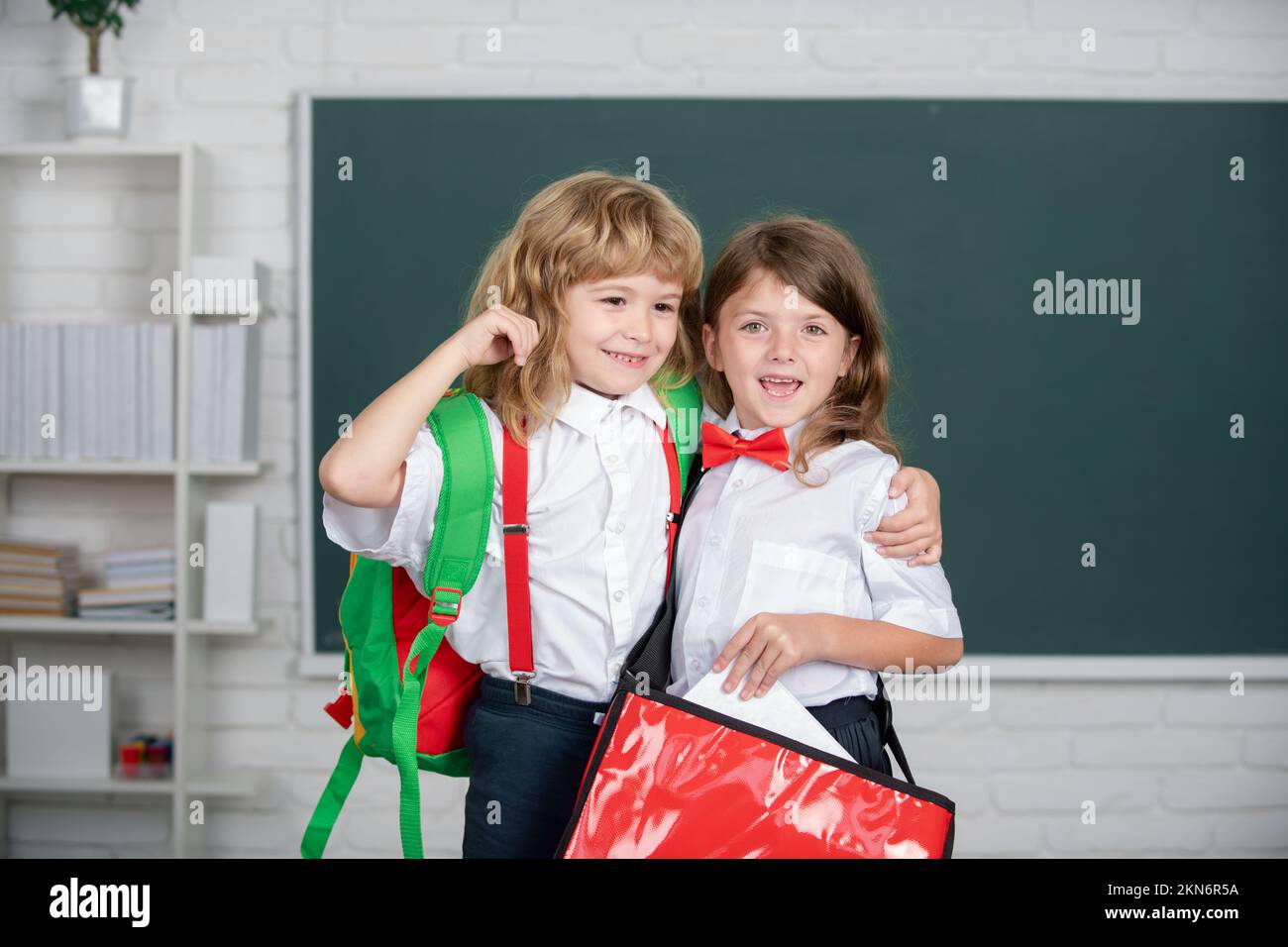 Back to school. Portrait of two happy school kids studying in classroom ...