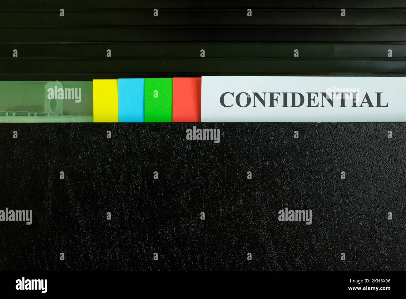 Confidential file record in black binder folder. Confidential ...