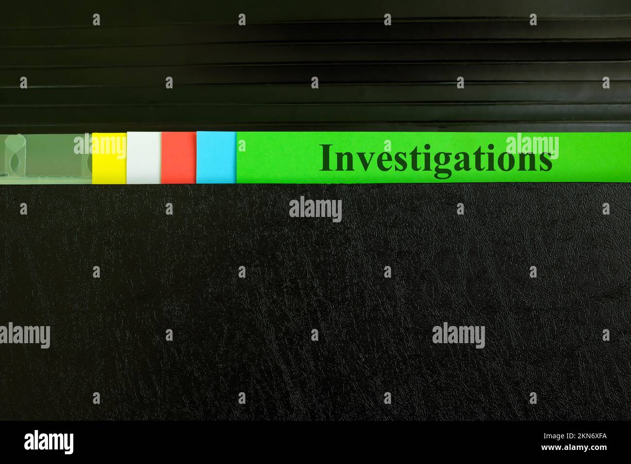 Investigations file record in black binder folder. Crime, legal and ...
