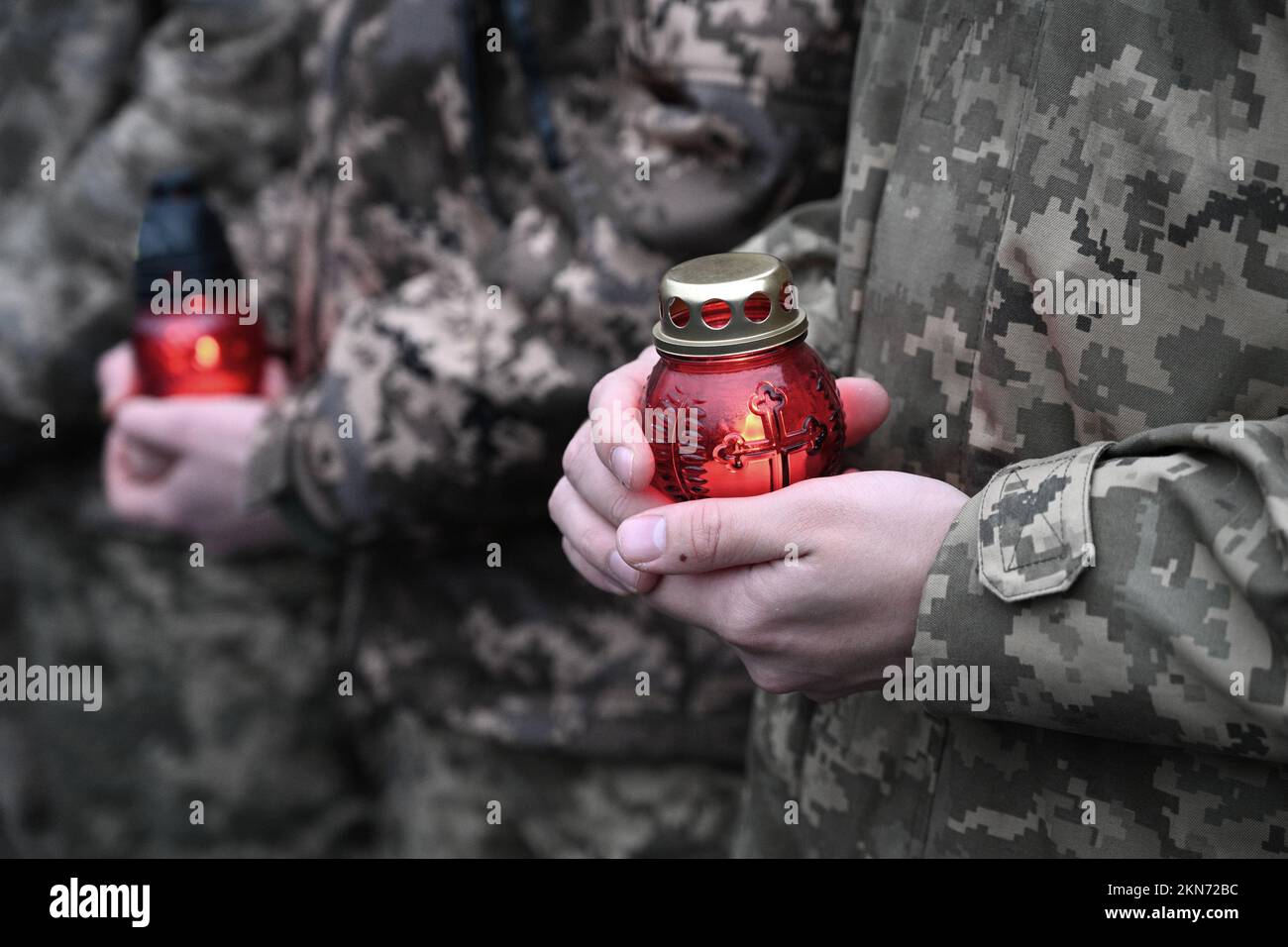 Ukrainian seviceman holds a candle. Candle in hands of Soldier Stock ...
