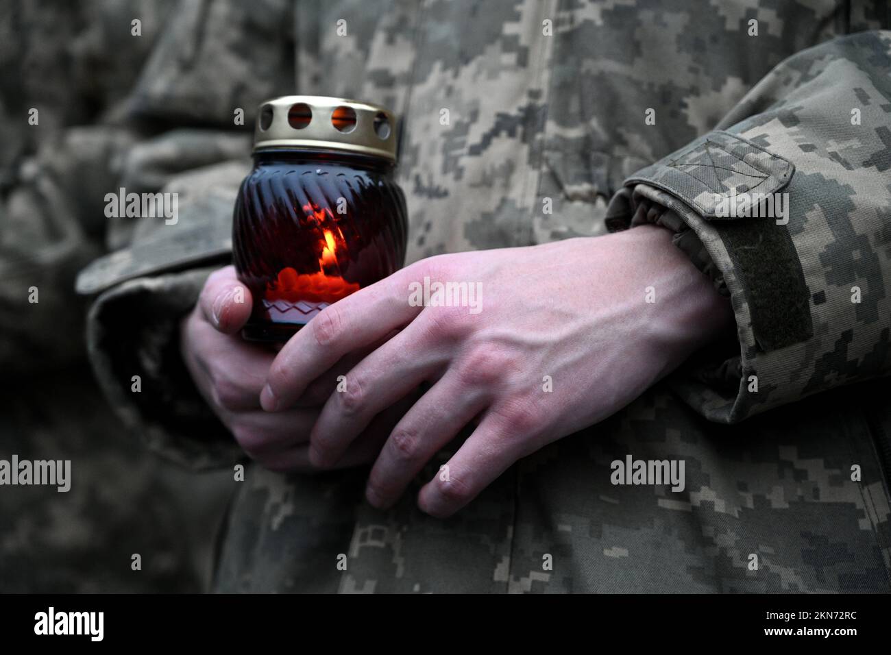 Ukrainian seviceman holds a candle. Candle in hands of Soldier Stock ...