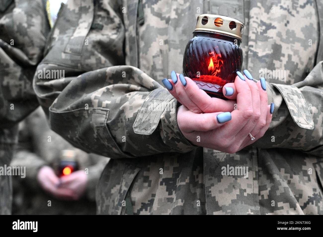 Ukrainian seviceman holds a candle. Candle in hands of Soldier Stock ...