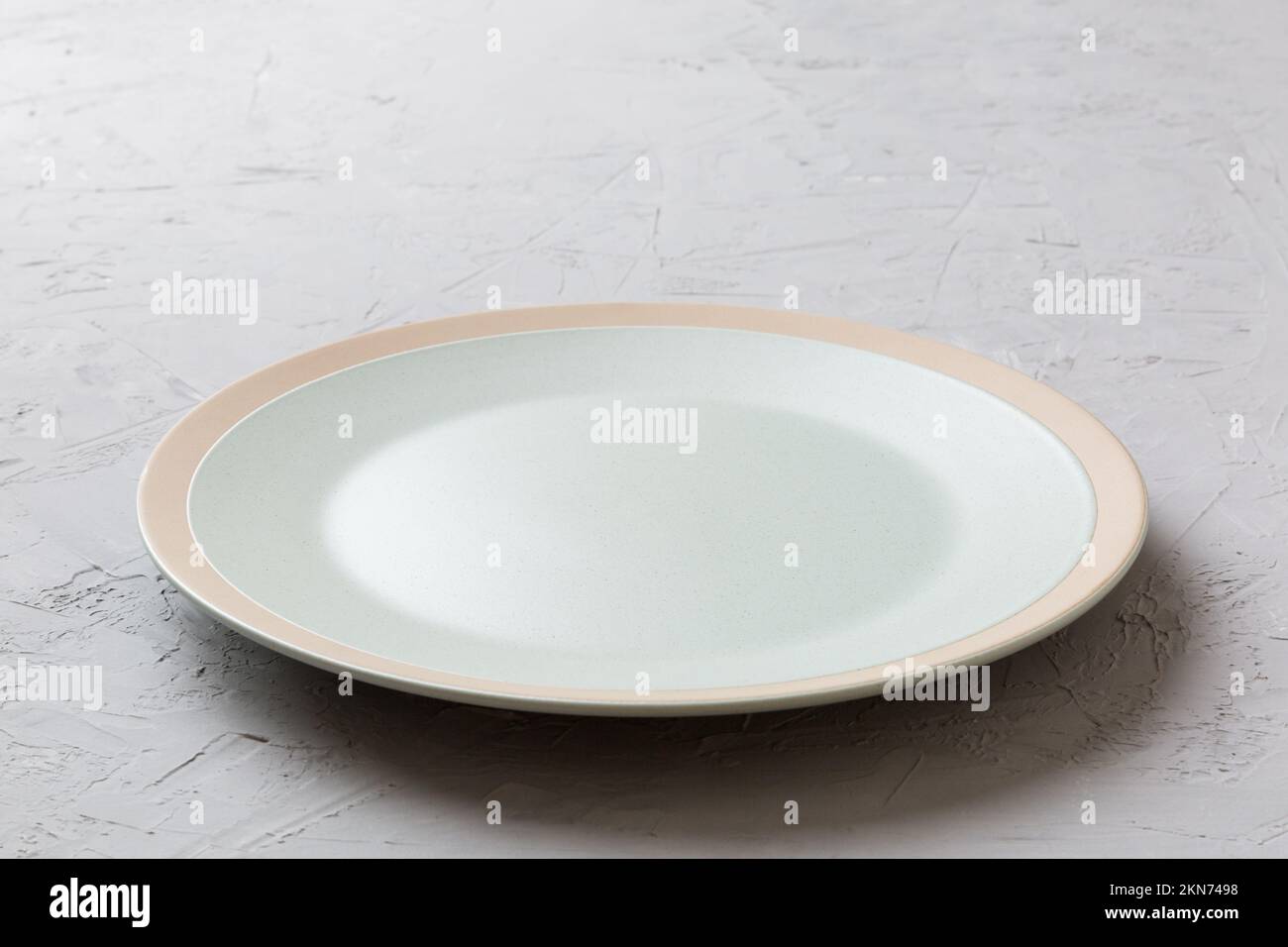 Perspective view of empty light plate on wooden background. Empty space ...