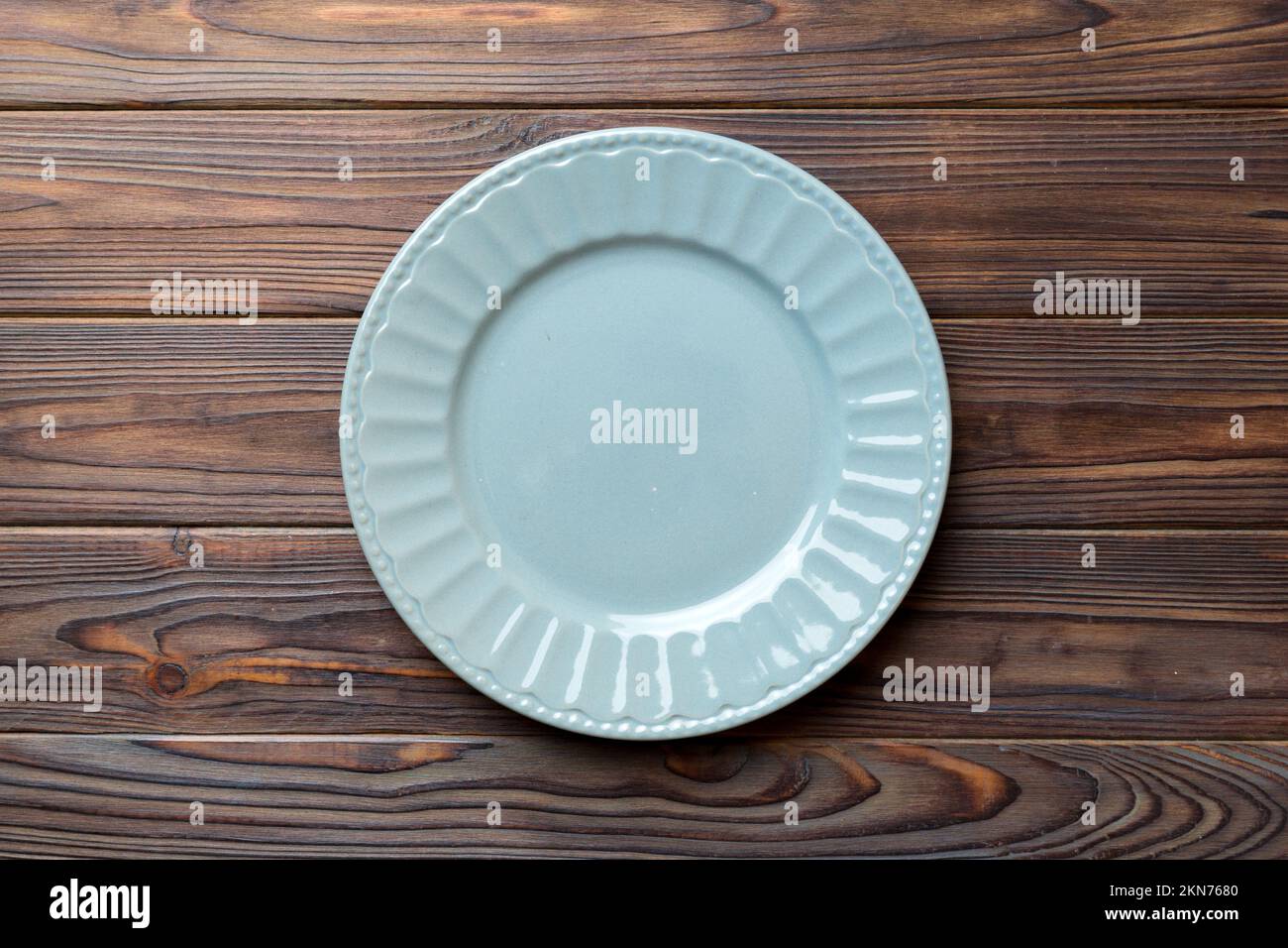 Top view of empty grey plate on wooden background. Empty space for your ...