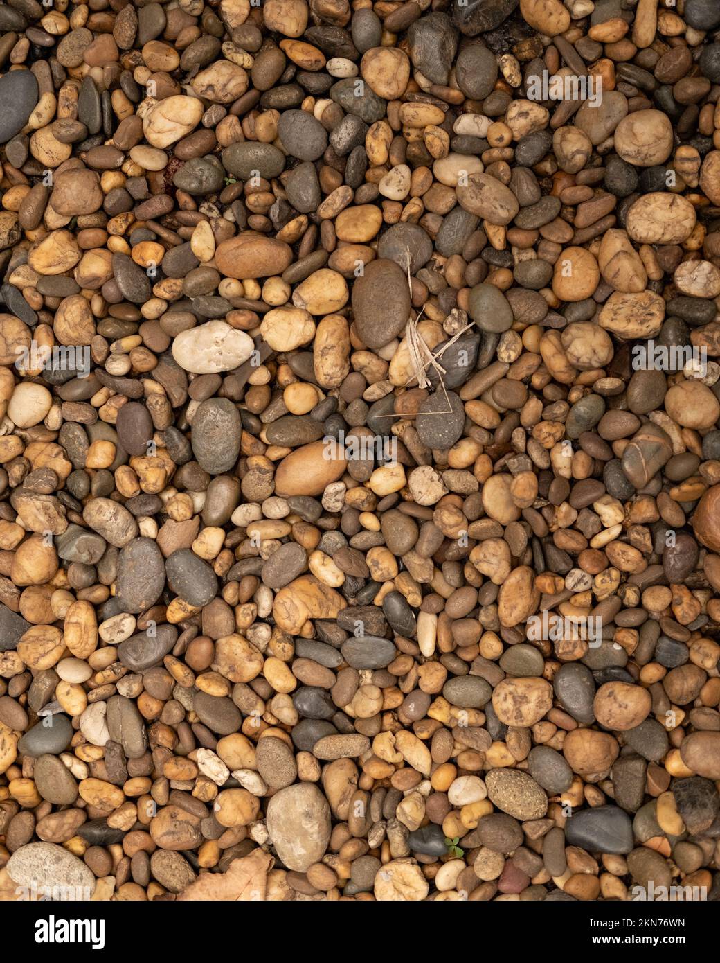 A vertical top view of thin pebbles on a stack Stock Photo - Alamy