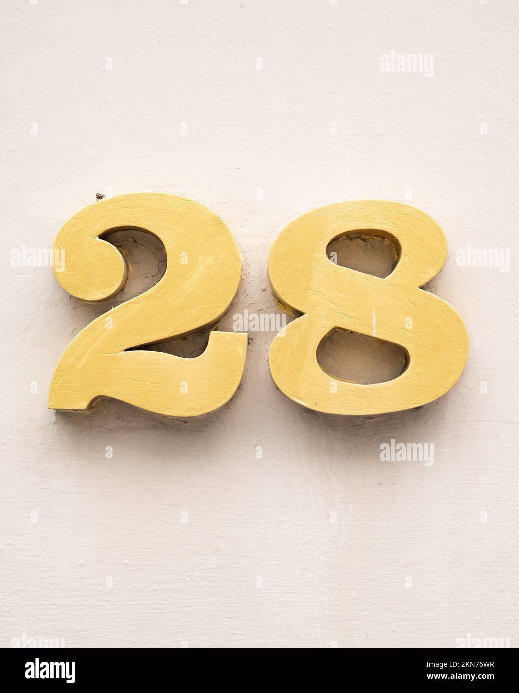 A vertical closeup of plaque plate number address of "28" house Stock ...