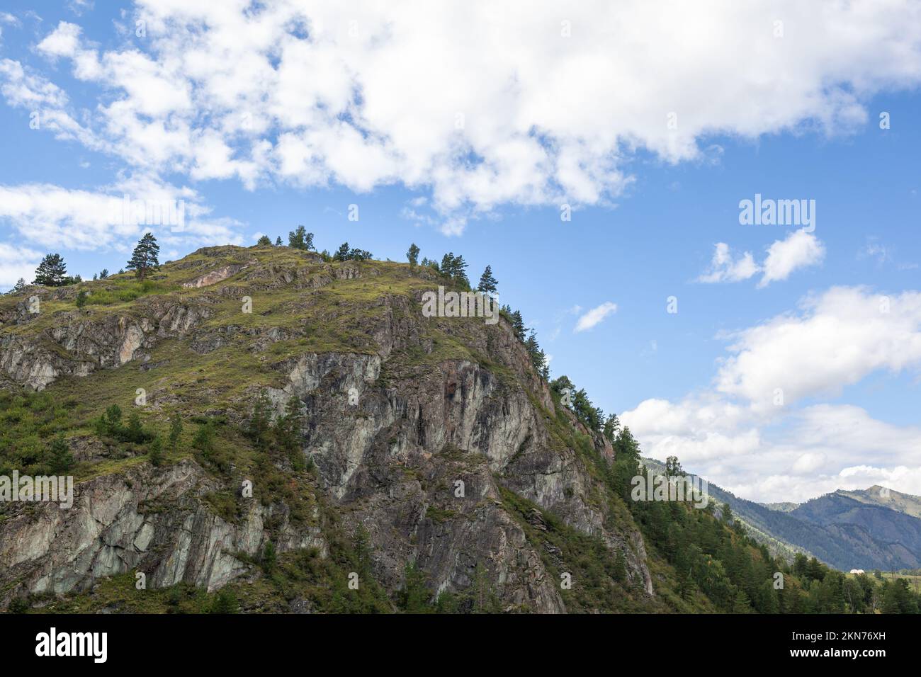 A large mountain with a sheer cliff close-up against the sky. Hiking ...