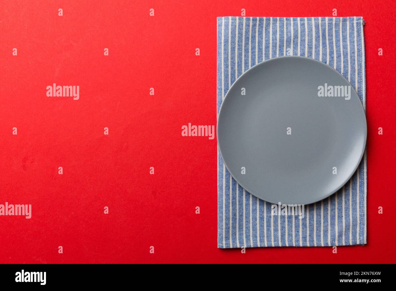 Top view on colored background empty round gray plate on tablecloth for ...