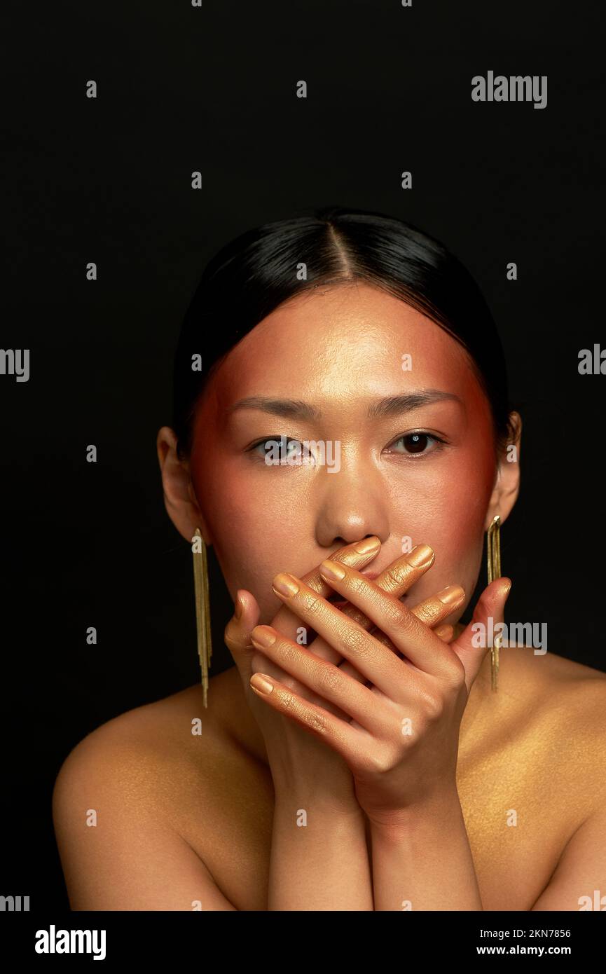 I'm not talking about evil. An Asian girl on a black background in the ...