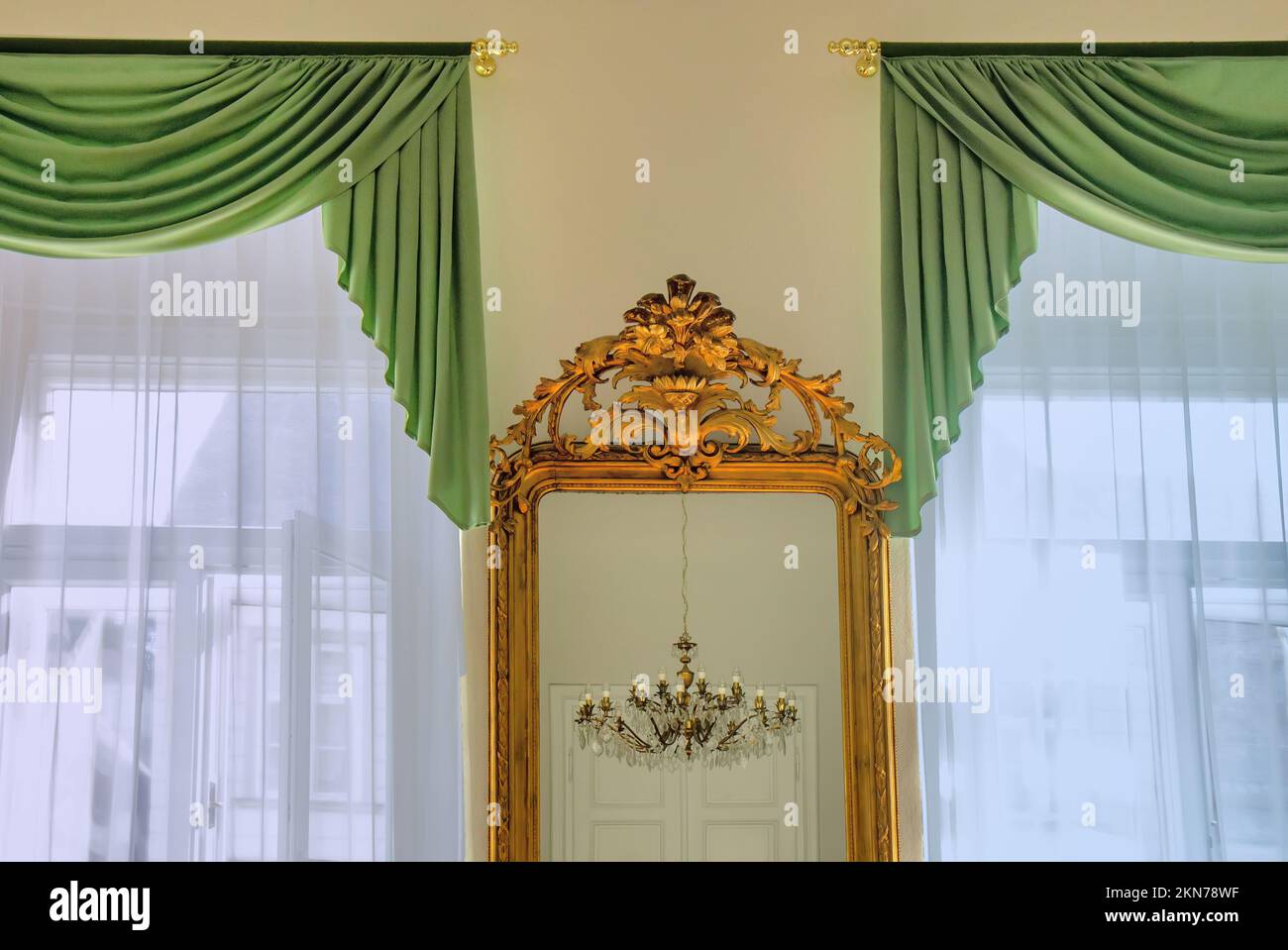 Old chandelier and mirror in the room Stock Photo - Alamy