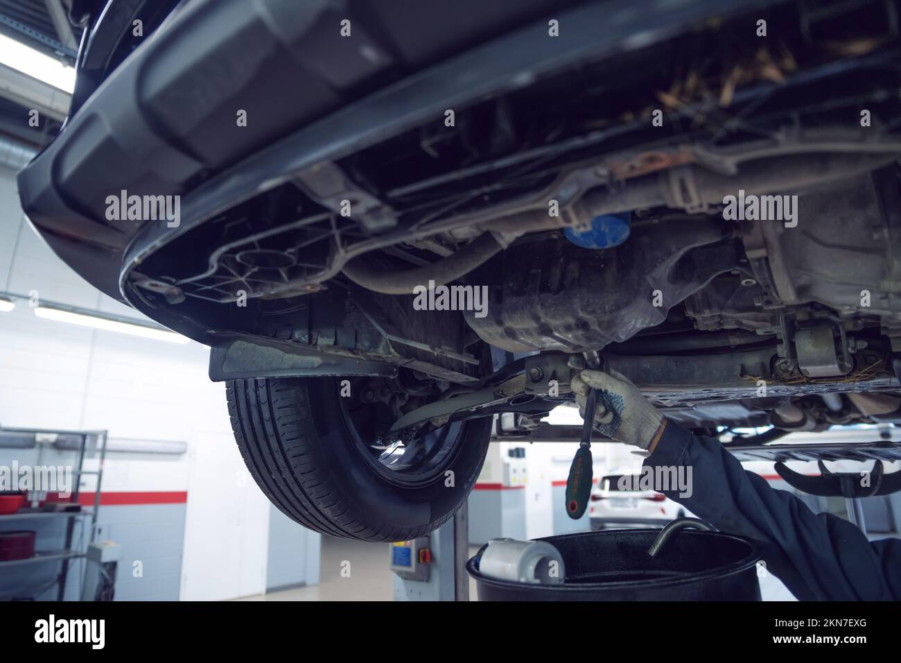 Car mechanic checks car on lift on Service station Stock Photo - Alamy