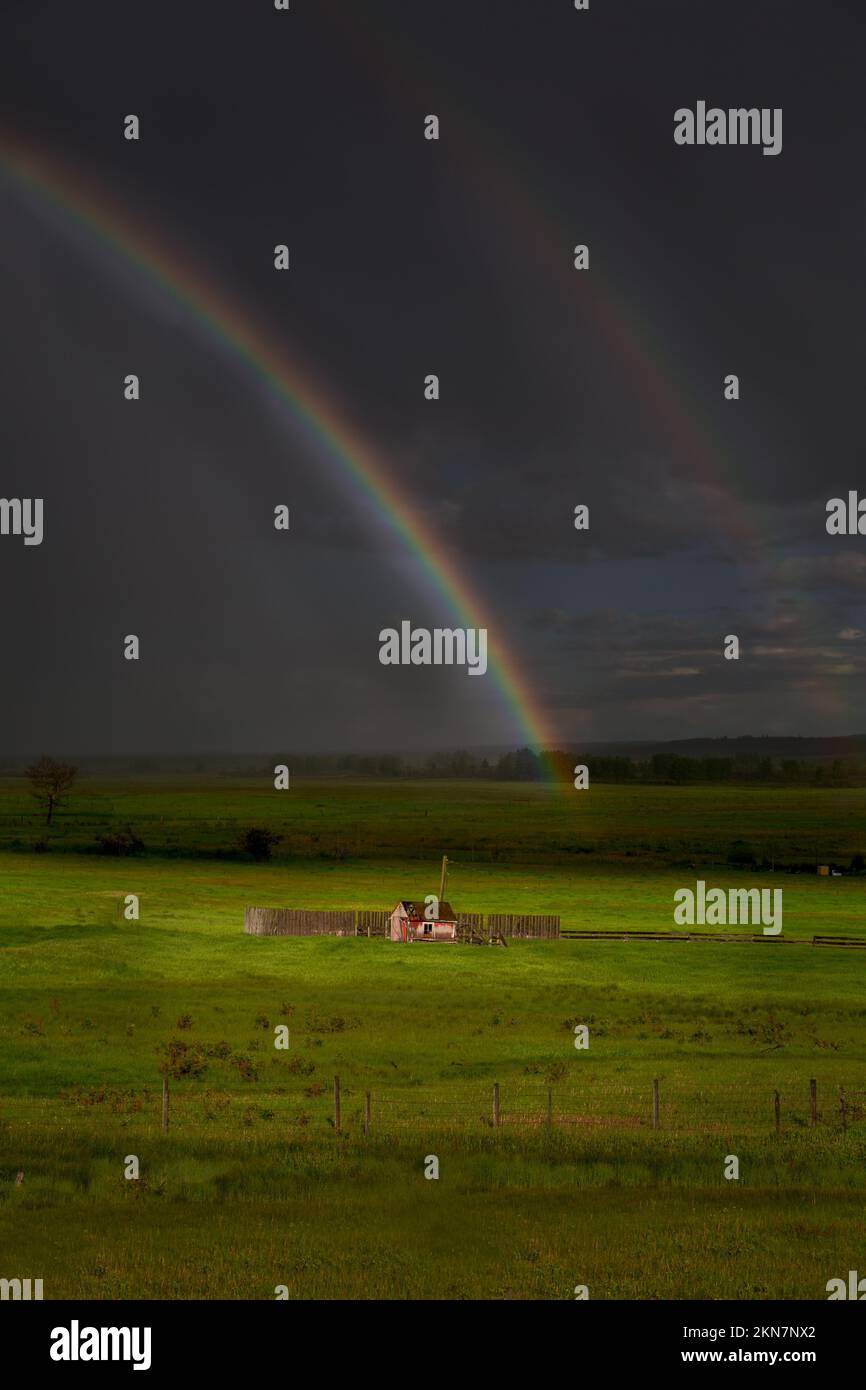Colorful double rainbow over green fields Stock Photo - Alamy