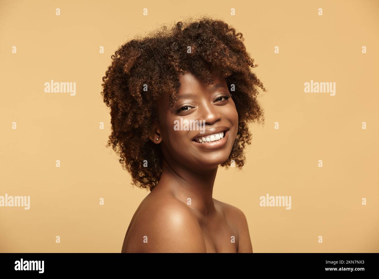 Portrait of African American woman with a clean healthy skin on a beige ...