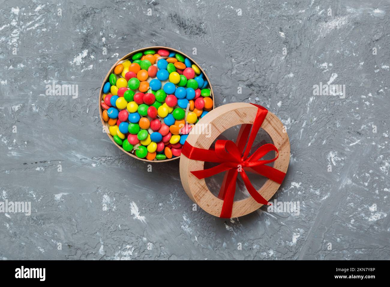 Set of different sweet candy in a paper box with a satin ribbon on a ...