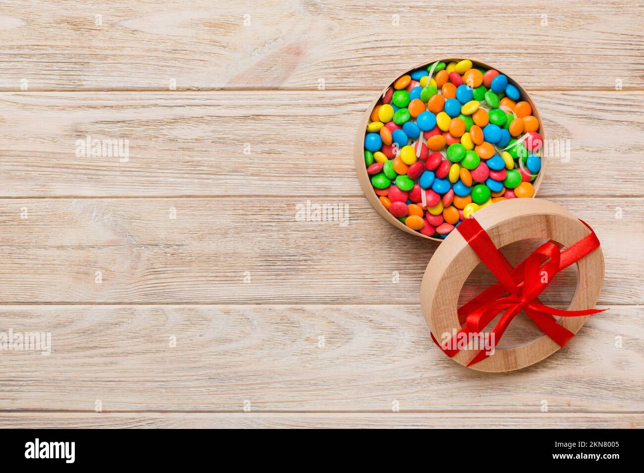 Set of different sweet candy in a paper box with a satin ribbon on a ...